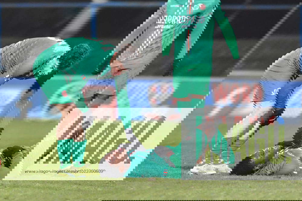 Virton s Kino Delorge checks up on his teammate Virton s Keres Masangu ...