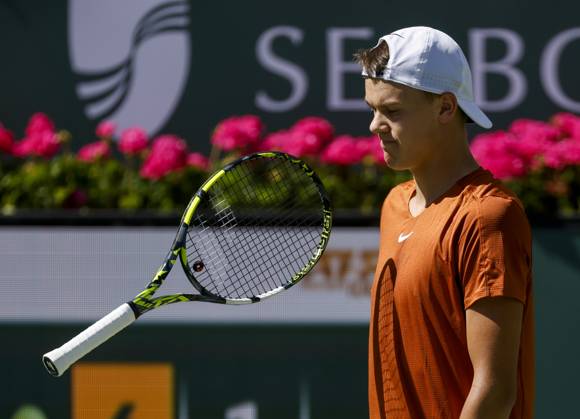 Holger Rune of Denmark tosses his racket against Stan Wawrinka of ...
