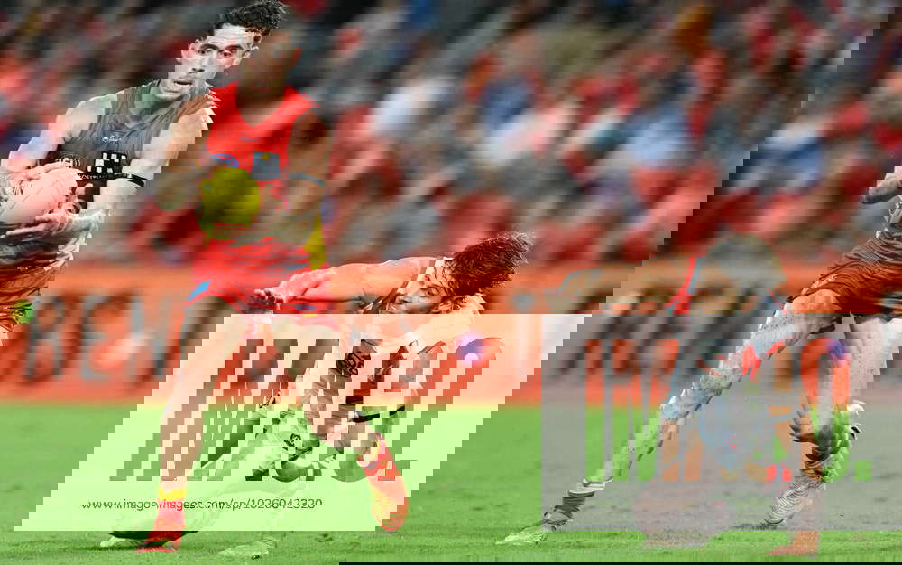 AFL SUNS SWANS, Sam Flanders (left) of the Suns in action during the ...