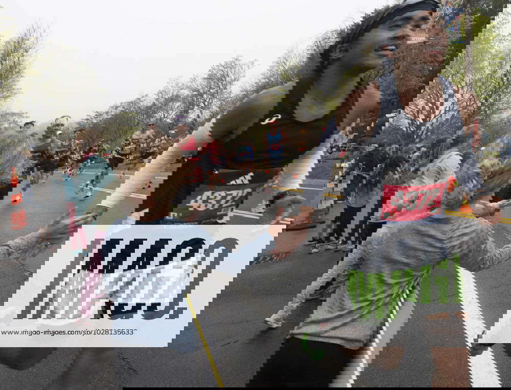 April 17, 2023, Newton, Massachusetts, USA: A runner slaps the hand of ...