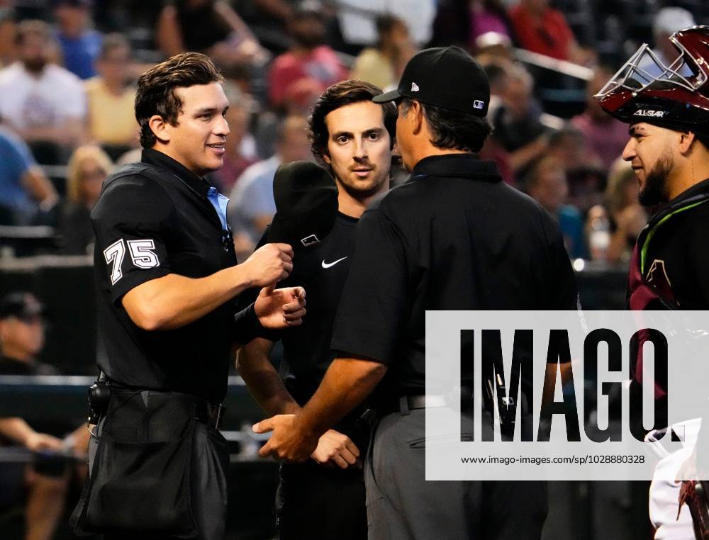 Syndication: Arizona Republic Umpire Edwin Jimenez (75) takes a time out after being hit in the