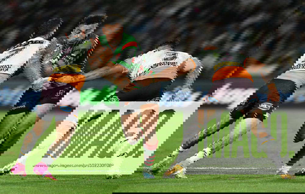 NRL RABBITOHS BRONCOS, Isaiah Tass (centre) of the Rabbitohs is tackled by Adam Reynolds (left) and