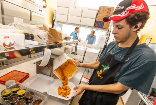 Syndication: Ocala StarBanner Dominick Gordon makes an order of wings ...