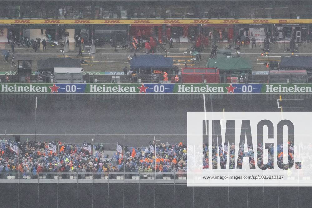 ZANDVOORT - Aerial view of F1 cars parked in the pit lane in the rain ...