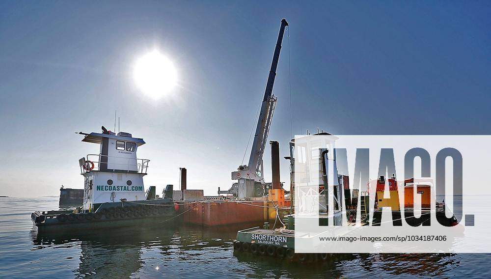 Syndication: The Patriot Ledger Barges and a crane surround a Long ...