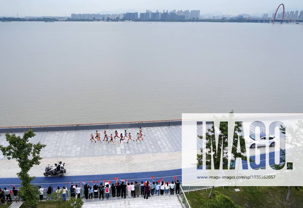 Asian Games: Marathon Runners proceed along the banks of the Qiantang ...