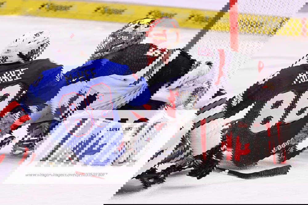 Kevin McKee of USA, left, and goalkeeper of Canada Adam Kingsmill in ...