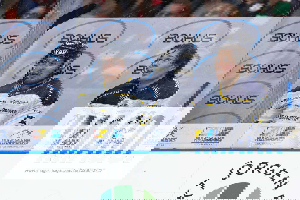 231014 HV71s Victor Sjöholm and Mans Lindbäck in the penalty box during the SHL ice hockey match