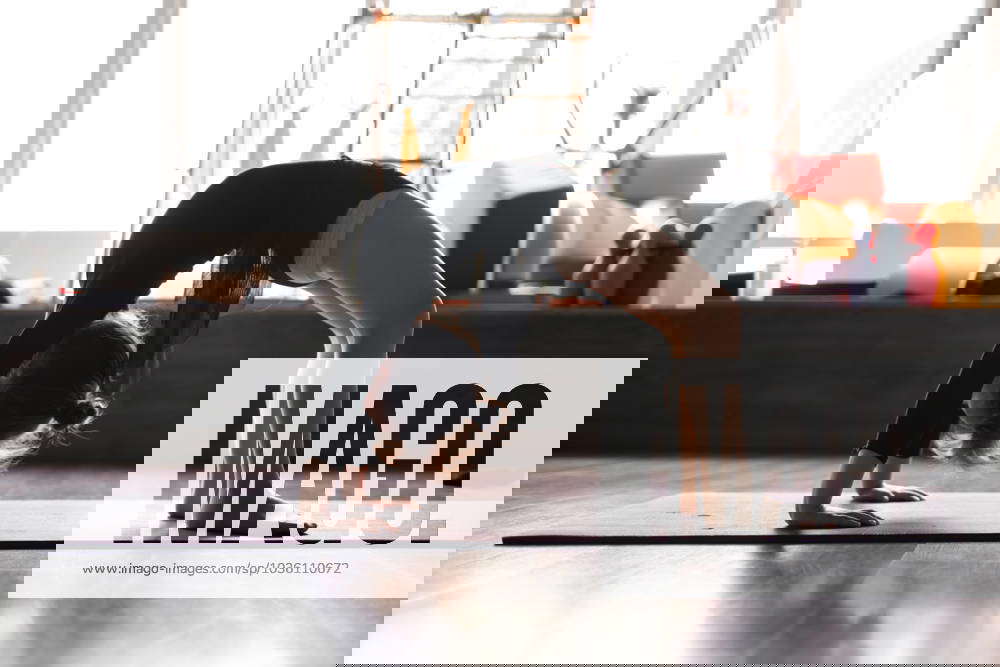 Small girl doing bridge stand exercise in the training studio. Yoga for ...