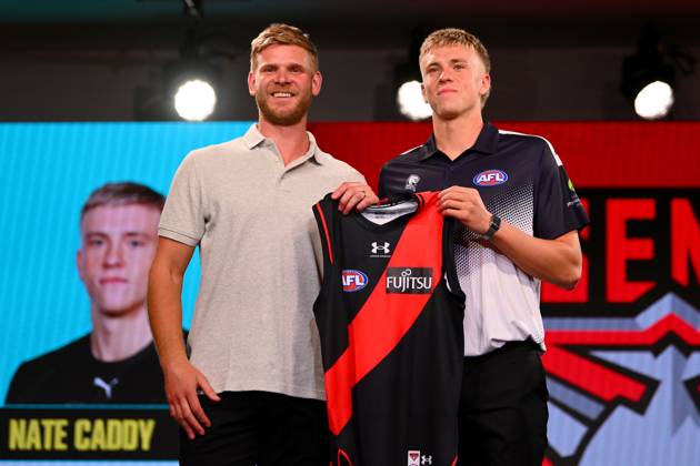 2023 AFL DRAFT, Michael Hurley presents Nate Caddy with an Essendon guernsey during the first-round