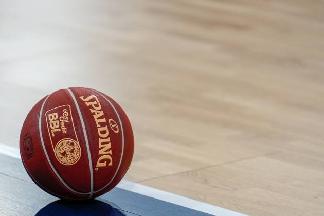 A Spalding brand ball lies on the ground and shows the logo of the ...