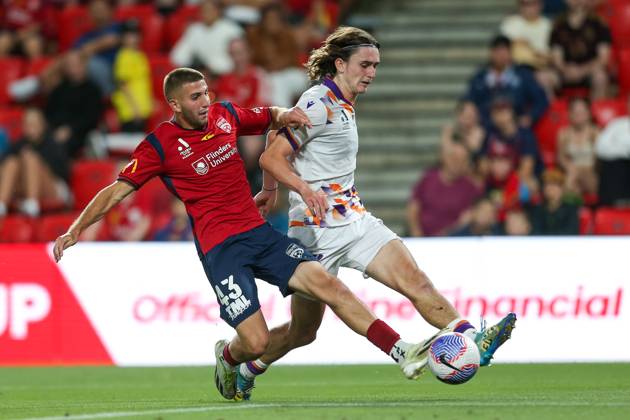 ALEAGUE ADELAIDE GLORY, Mitchell Oxborrow of the Glory is tackled by ...
