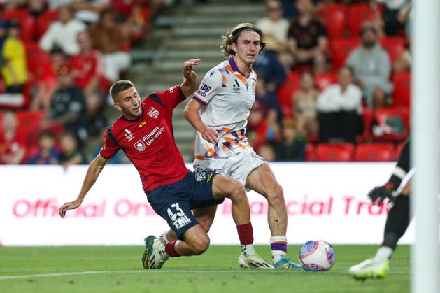 ALEAGUE ADELAIDE GLORY, Mitchell Oxborrow of the Glory is tackled by ...