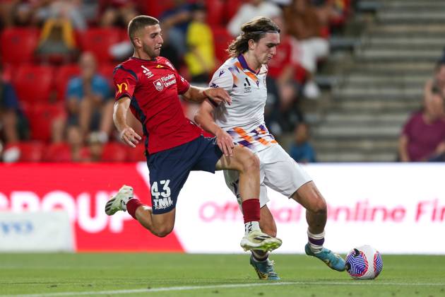 ALEAGUE ADELAIDE GLORY, Mitchell Oxborrow of the Glory is tackled by ...