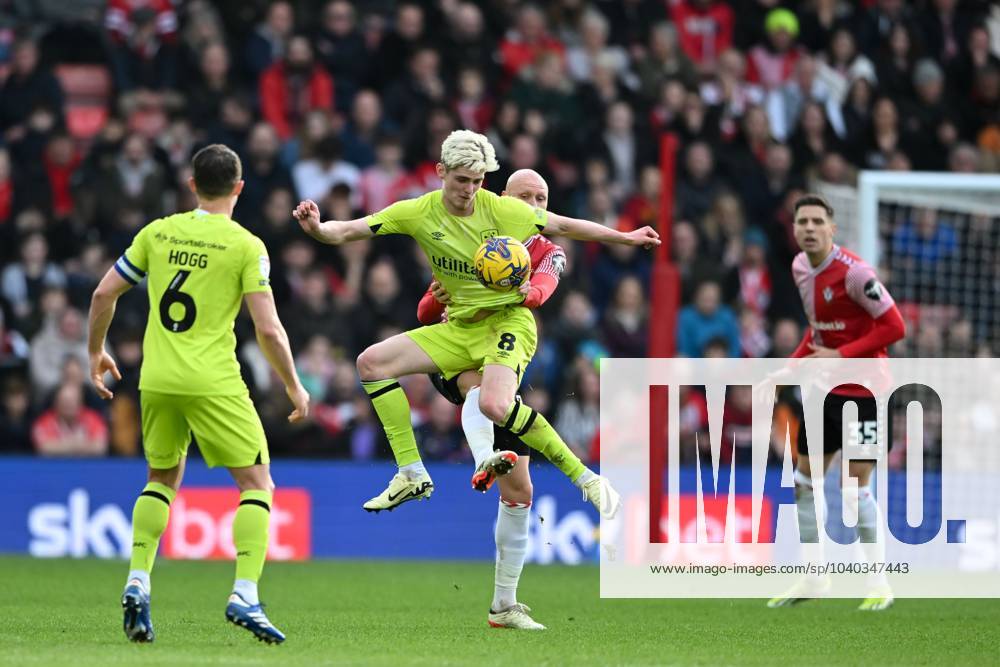 Jack Rudoni of Huddersfield Town under pressure from Will Smallbone of ...