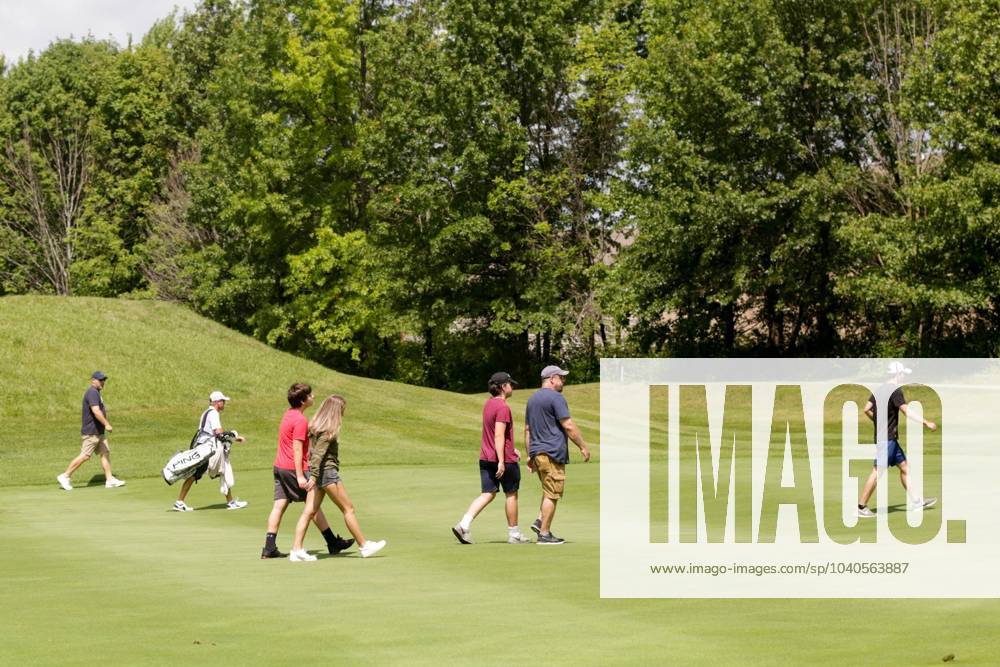 Syndication: LafayetteIN Spectators walk across the fairway during the ...