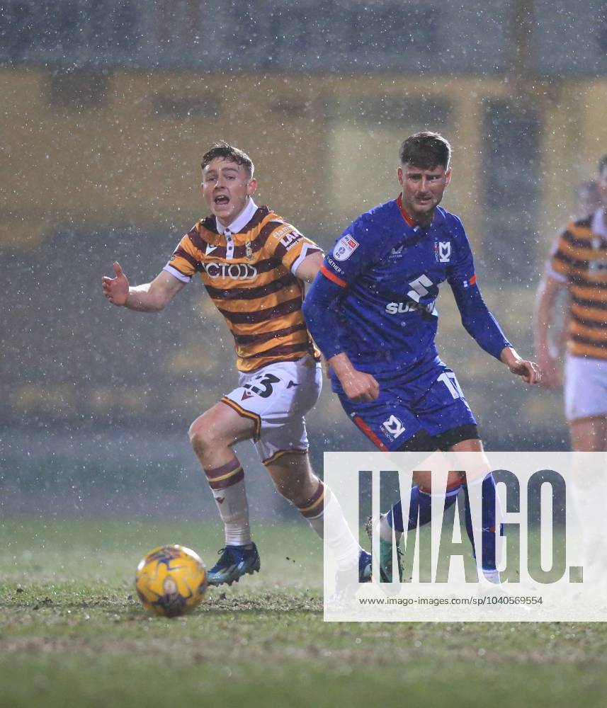 Bobby Pointon of Bradford City challenges Ethan Robson of MK Dons ...