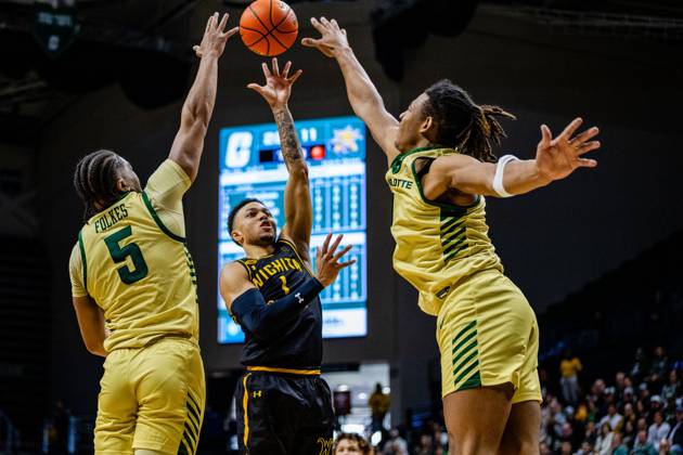 : Wichita State Shockers guard Xavier Bell shoots over Charlotte 49ers ...