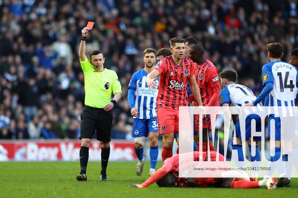 Match referee Tony Harrington shows Billy Gilmour of Brighton & Hove ...