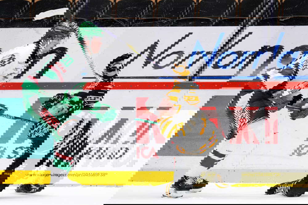 240229 Rögles Lian Bichsel and Skellefteas Andreas Johnson during the SHL ice hockey match between