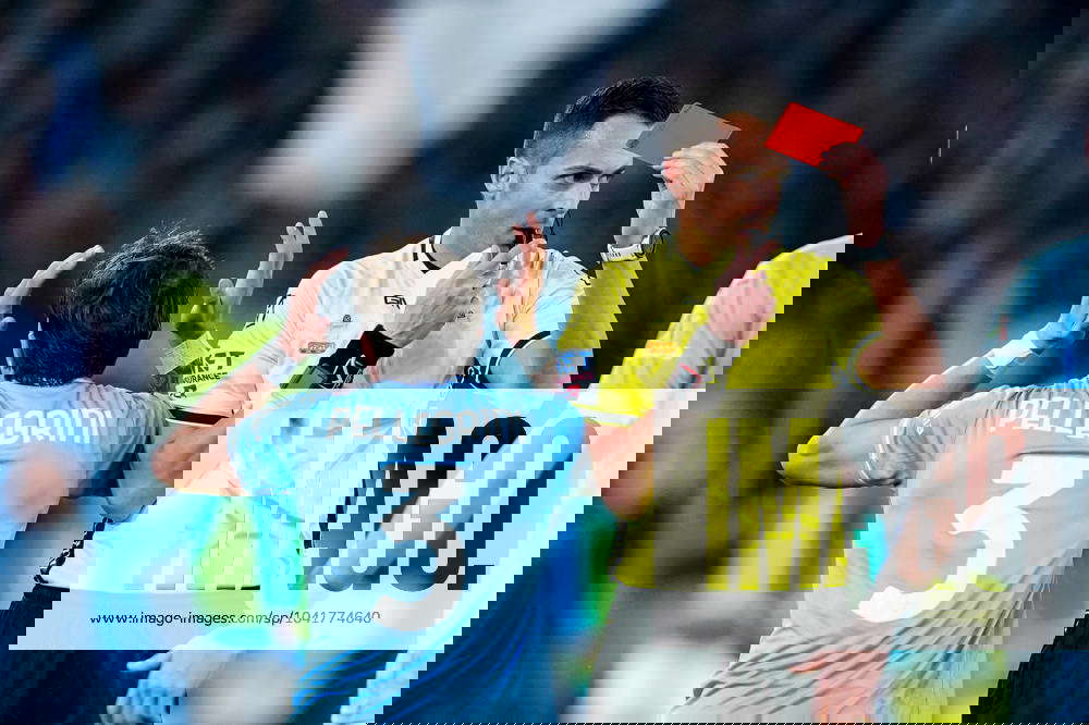 Referee Marco Di Bello shows a red card to Luca Pellegrini of SS Lazio during the Serie A match