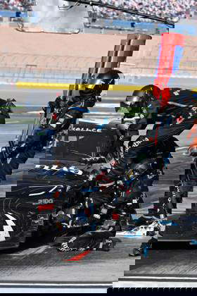 LAS VEGAS, NV - MARCH 03: Pit crew members works to fix the wheel of ...