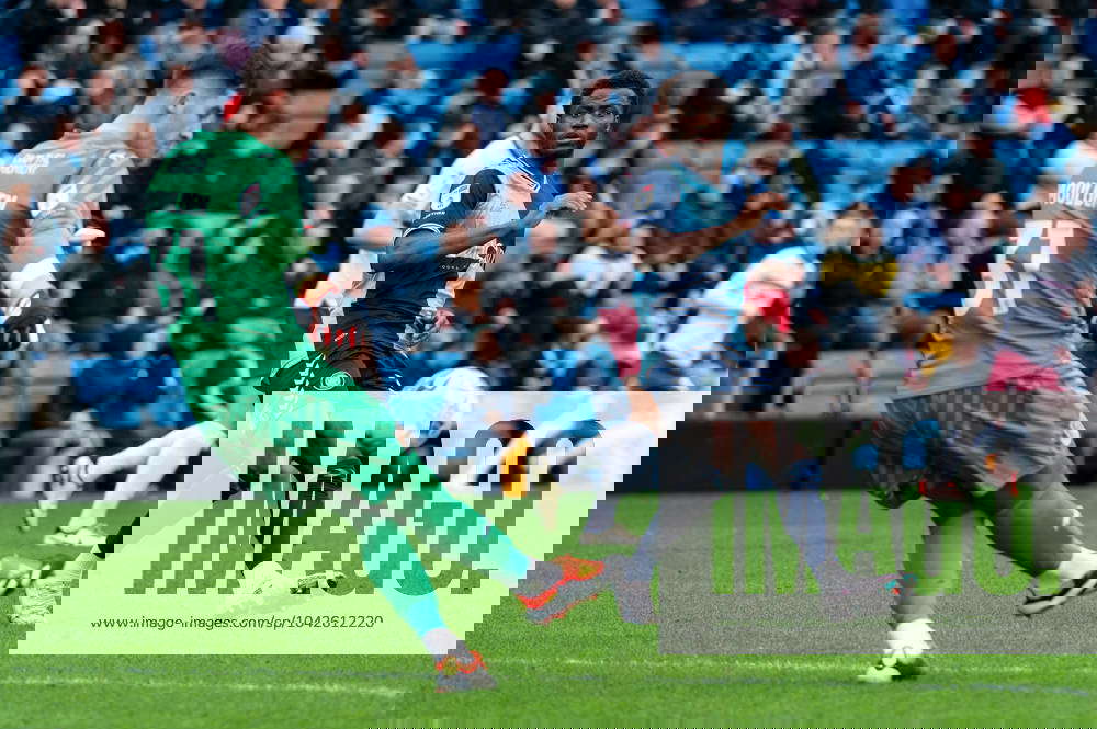 Beryly Lubala of Wycombe Wanderers watches Goalkeeper Louis Moulden of ...