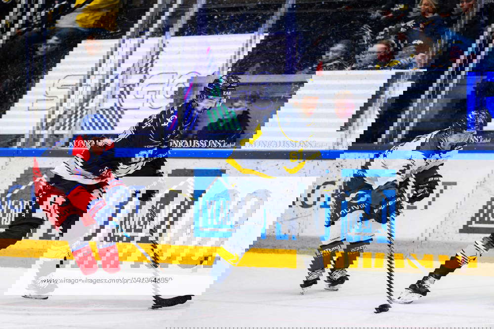 240317 Oskarshamns Niclas Burström and HV71s Oliwer Kaski during match two in the SHL qualifier