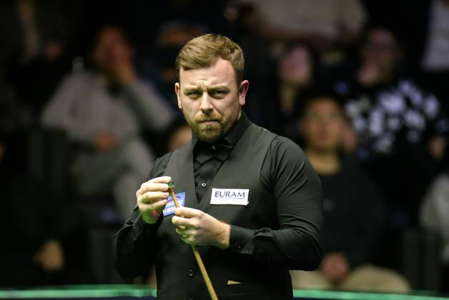 SHANGRAO, CHINA - MARCH 19: Oliver Brown of England chalks the cue in ...