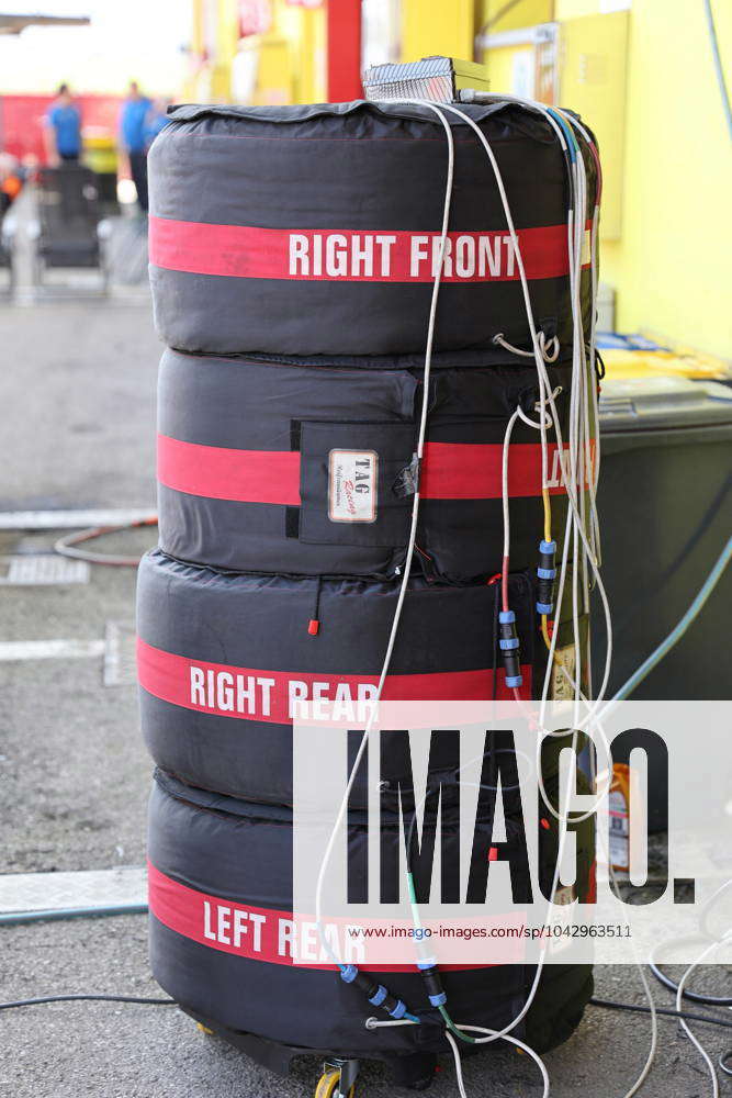 Racing tires warmed in heating blankets wait in the pits for their use ...