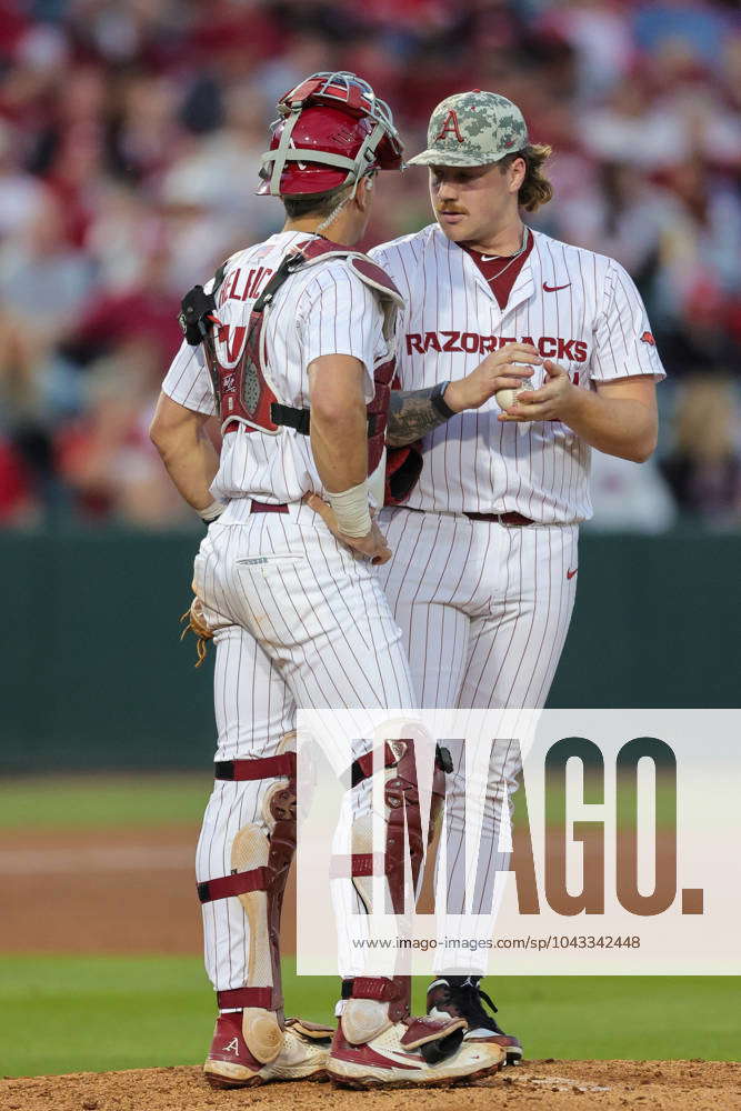 : Arkansas catcher Ryder Helfrick 27 visits with Mason Molina 21 on the ...