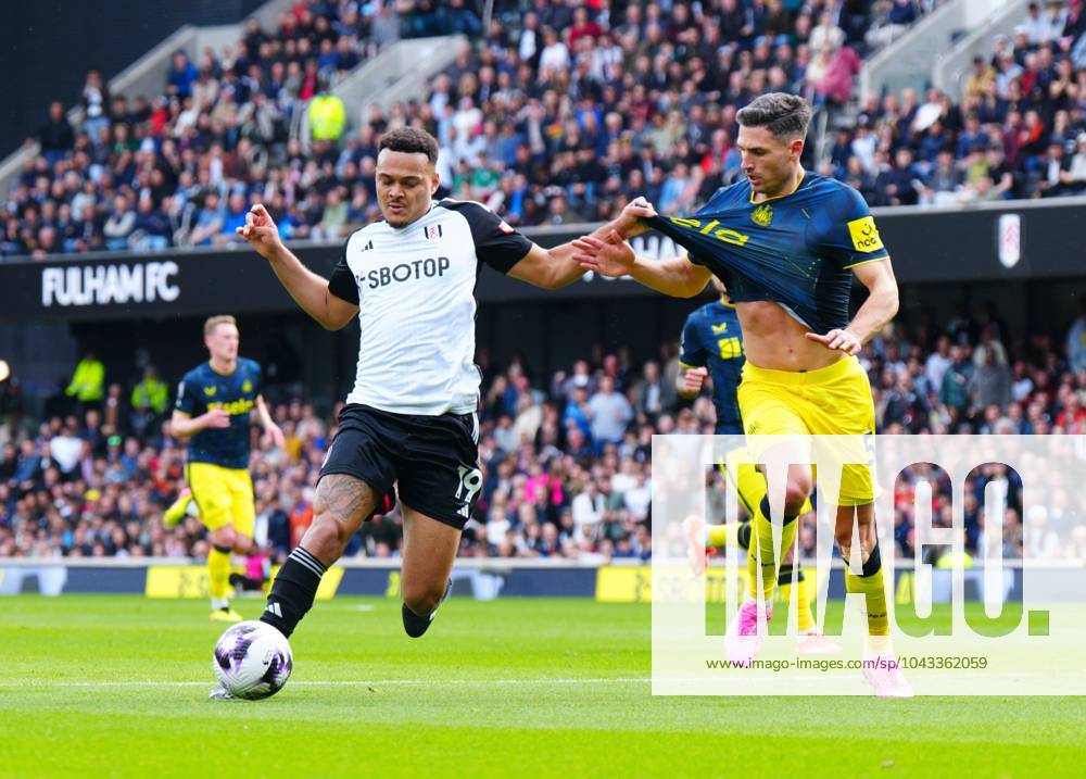 Rodrigo Muniz of Fulham grapples with Fabian Schar of Newcastle United ...