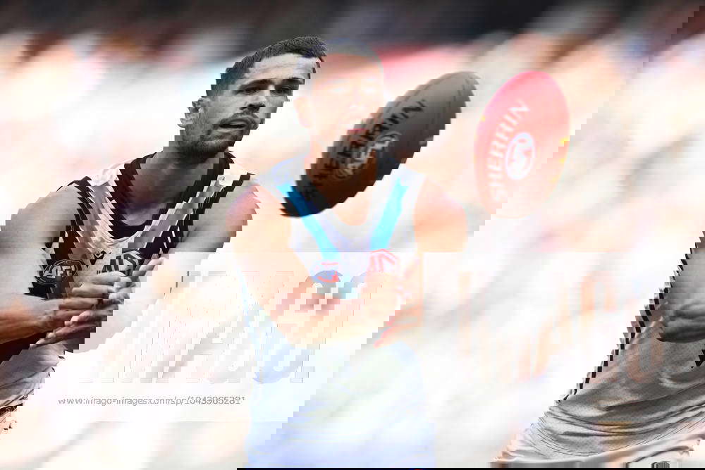 AFL MAGPIES POWER, Ryan Burton of Port Adelaide handballs the footy ...