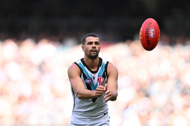 AFL MAGPIES POWER, Ryan Burton of Port Adelaide handballs the footy ...