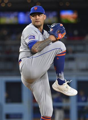 New York Mets starting pitcher Sean Mainea winds up to deliver against ...