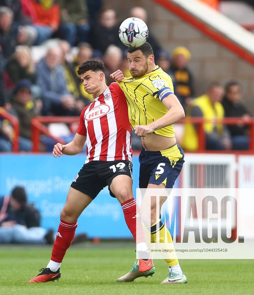 Sonny Cox of Exeter City and Elliott Moore of Oxford United in action ...