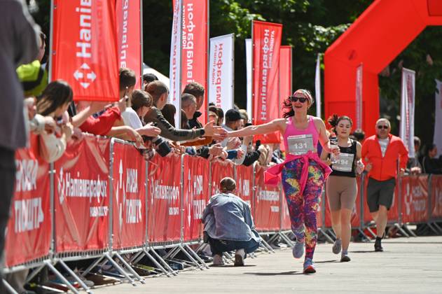 Charity half marathon in Lviv A smiling man wrapped in a Ukrainian flag ...