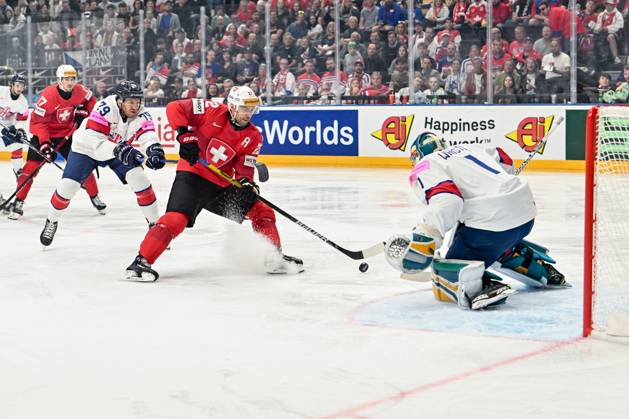 PRAGUE, CZECH REPUBLIC MAY 12 Nino Niederreiter of Switzerland defends the puck against Mario