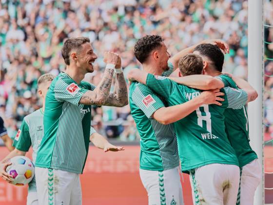 Anthony Jung 03 SV Werder Bremen SVW in front of banner, fan poster ...