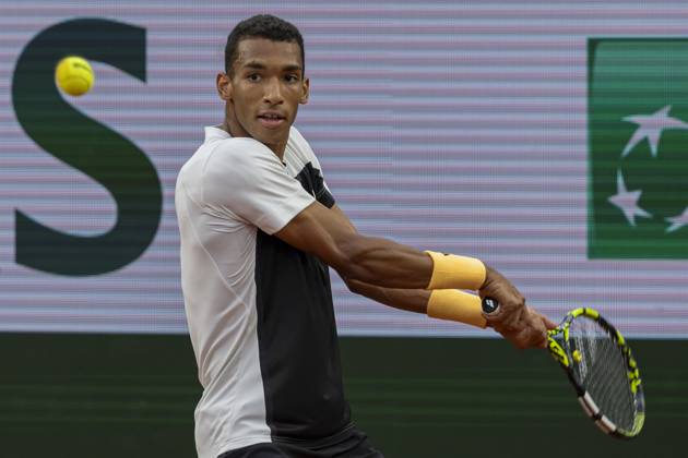 Roland Garros 2024 - Day 7 Felix Auger-Aliassime is returning the ball against Ben Shelton during