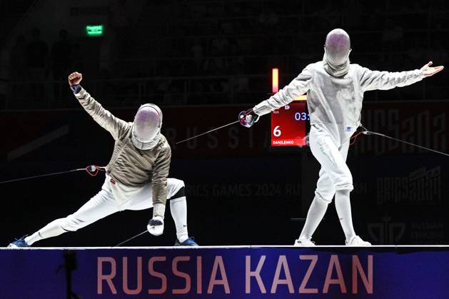 RUSSIA, KAZAN - : Russia’s Dmitry Danilenko and Uzbekistan s Musa Aymuratov embrace after their men