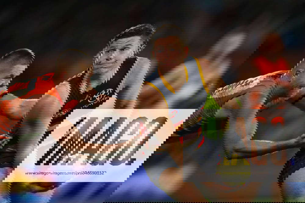 AFL CROWS GIANTS, Jake Soligo of the Crows is tackled by Harry ...