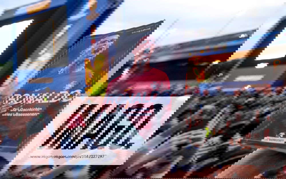 A fan holds a Cristiano Ronaldo book in the air GER, UEFA EURO 2024 ...