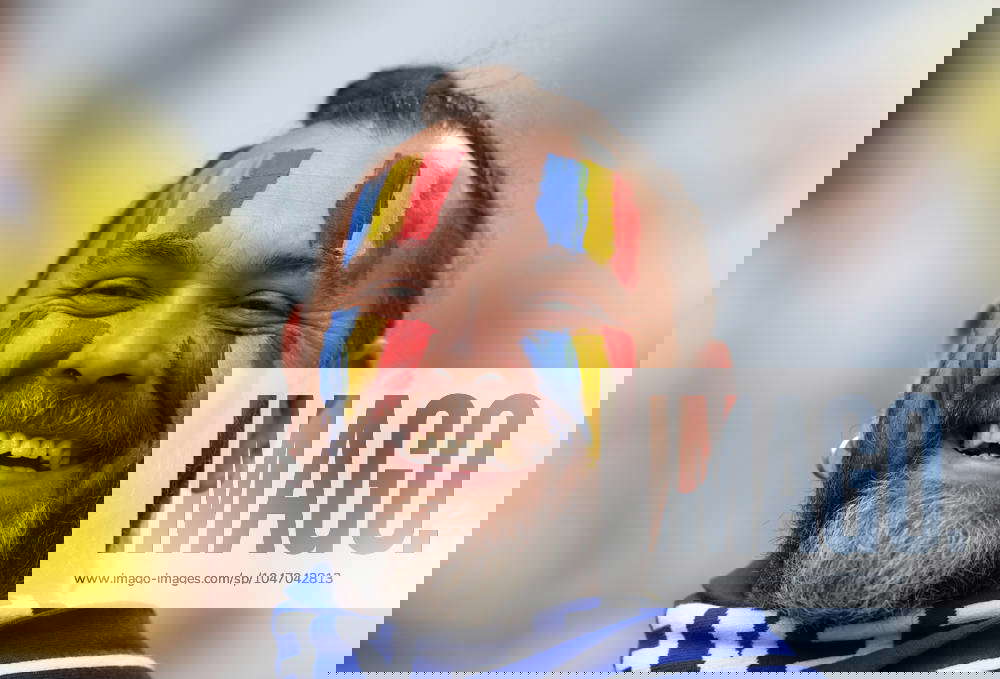 A Romania fan with face paint in the stadium ahead of the game Romania ...