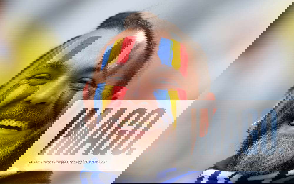 A Romania fan with face paint in the stadium ahead of the game Romania ...