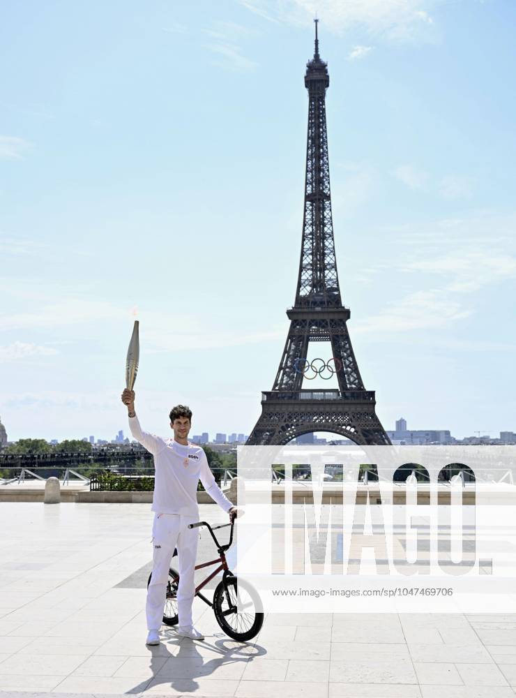 Paris Olympics: Torch relay A Paris Olympic torch relay runner holds up ...