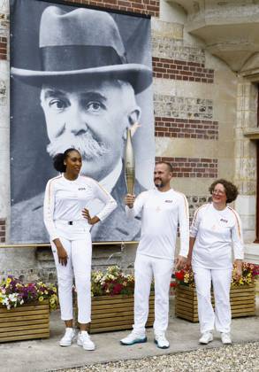 Paris Olympics: Torch relay A Paris Olympic torch relay runner holds up ...