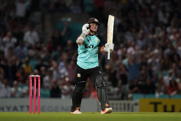 Sam Curran of Surrey raises his bat as he reaches 100 during the ...