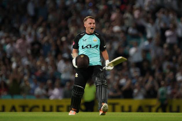 Sam Curran of Surrey raises his bat as he reaches 100 during the ...