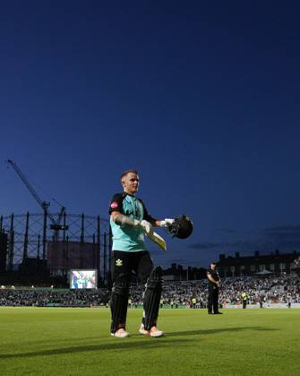 Sam Curran of Surrey raises his bat as he reaches 100 during the ...